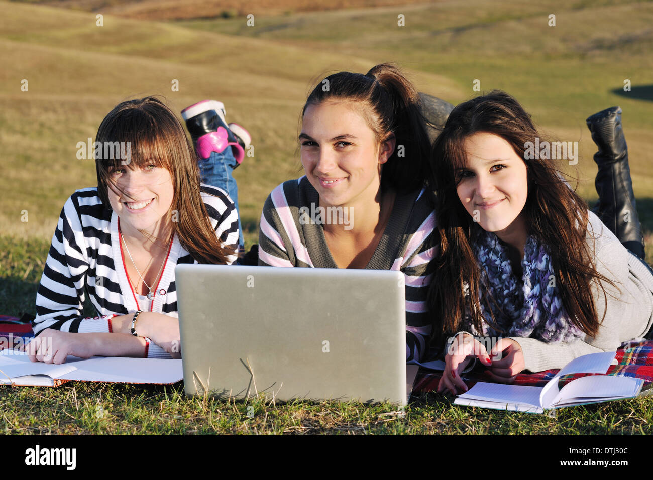 group of teens working on laptop outdoor Stock Photo - Alamy