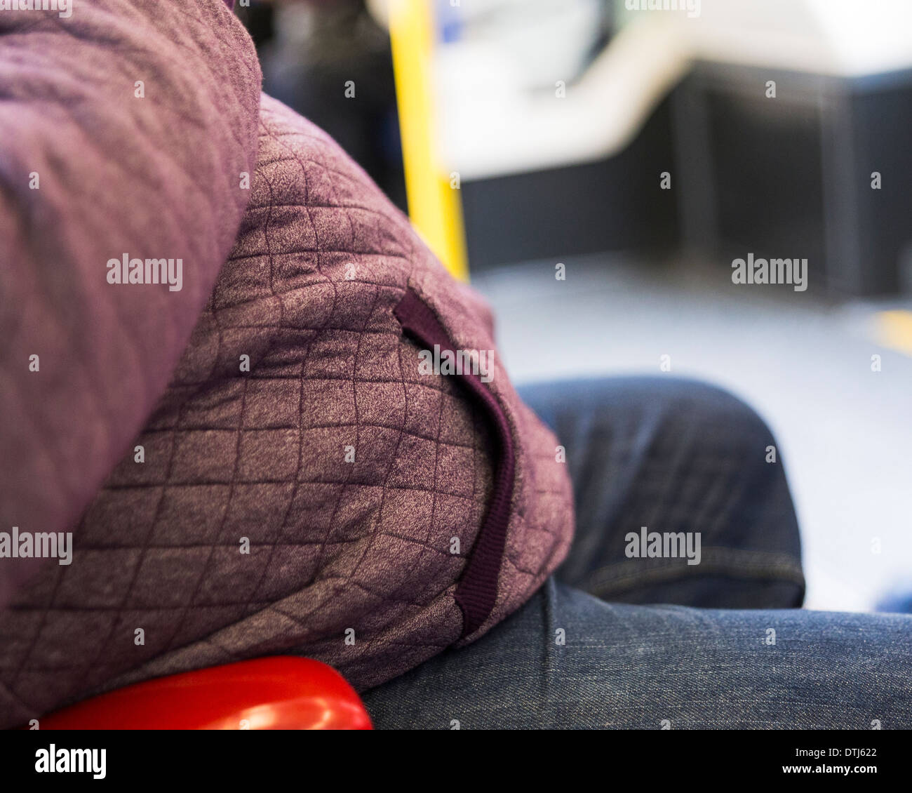 Overweight man seated inside a London Underground train Stock Photo - Alamy