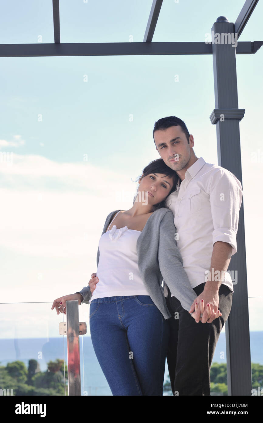 couple relaxing on balcony Stock Photo - Alamy