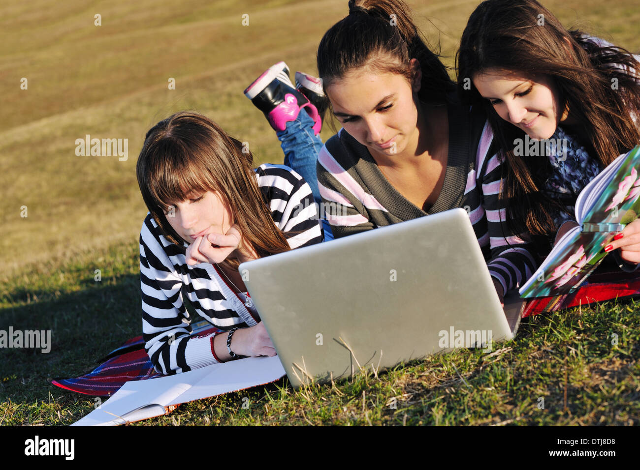 group of teens working on laptop outdoor Stock Photo - Alamy