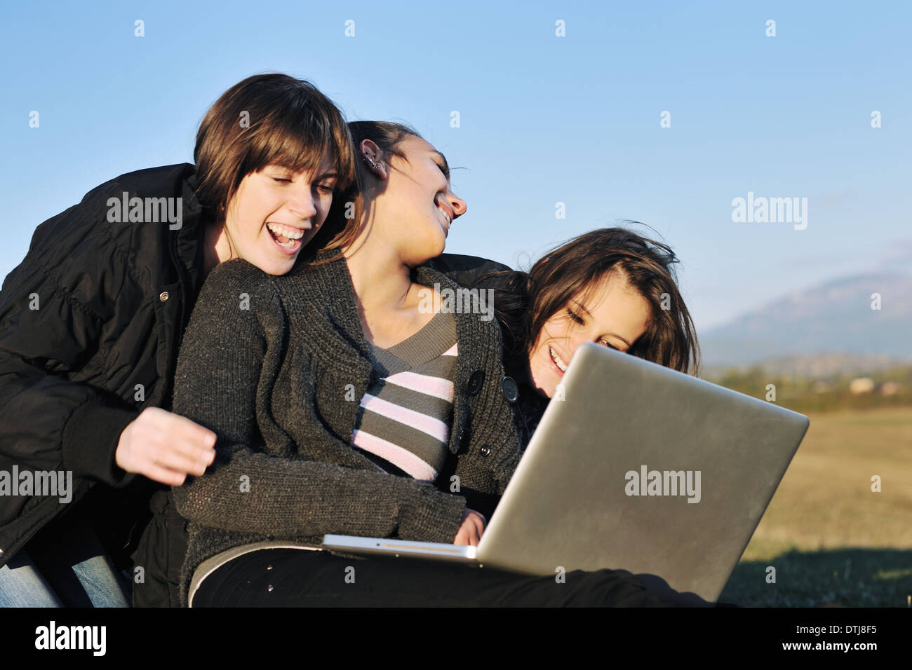 group of teens working on laptop outdoor Stock Photo - Alamy