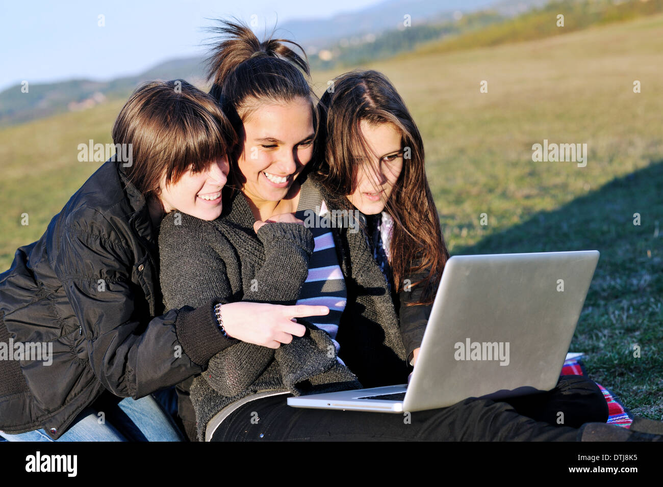 group of teens working on laptop outdoor Stock Photo - Alamy