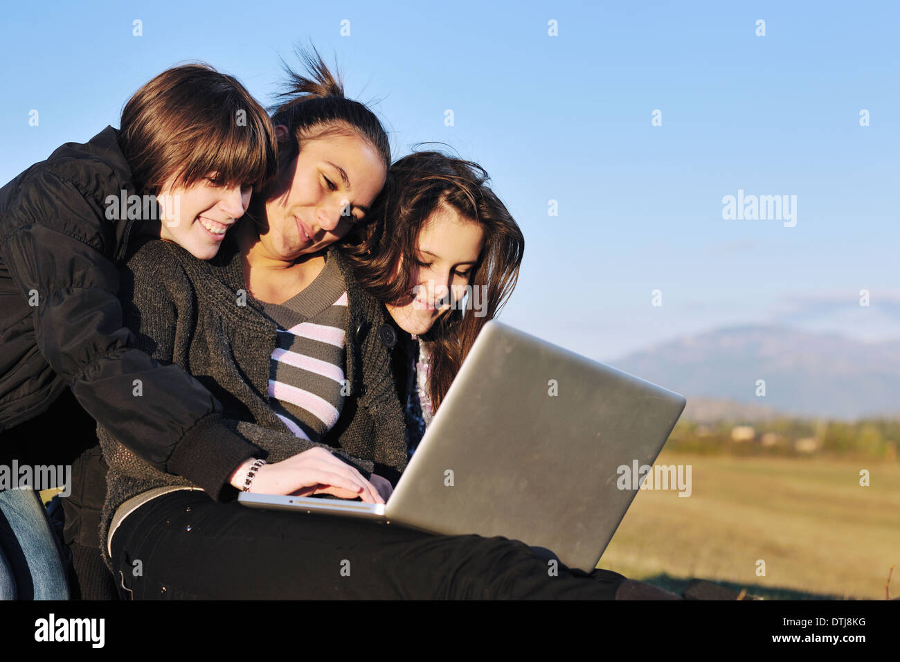 group of teens working on laptop outdoor Stock Photo - Alamy