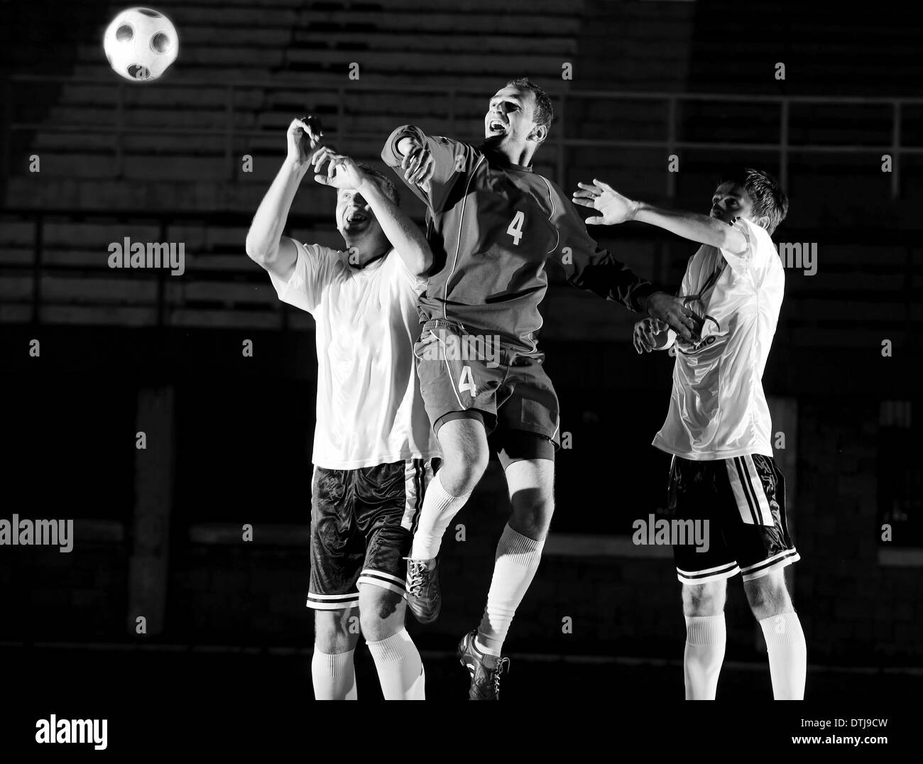 football players in action for the ball Stock Photo - Alamy