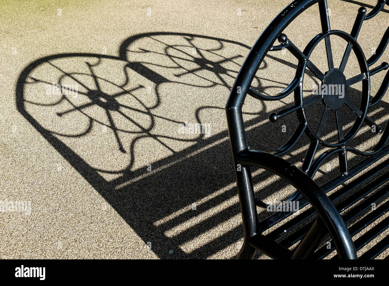 An intricate shadow cast by a metal bench Stock Photo - Alamy
