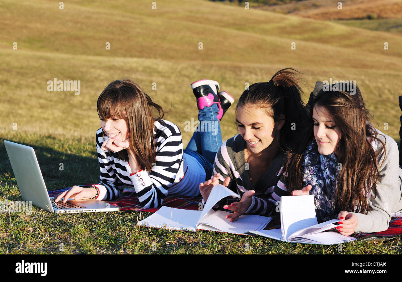 group of teens working on laptop outdoor Stock Photo - Alamy