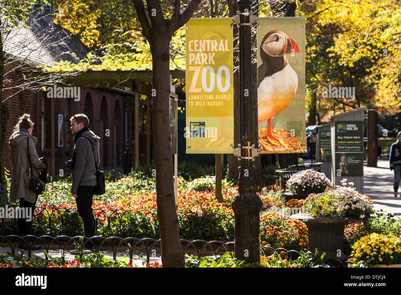 Couple, Central Park Zoo Next to Decorative Banner, NYC Stock Photo - Alamy
