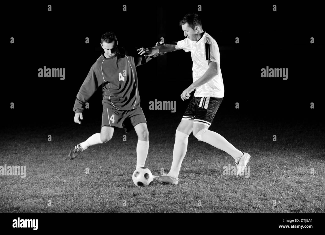 football players in action for the ball Stock Photo - Alamy