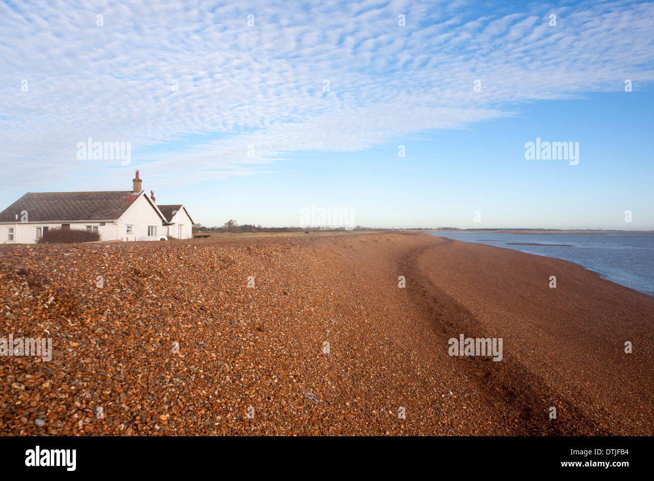 Bungalow beach house by steep shingle ridge at Shingle Street, Suffolk ...