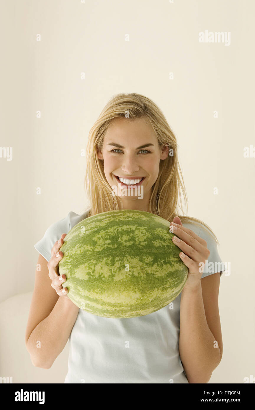 A woman holding a large green watermelon Cape Town South Africa Stock ...