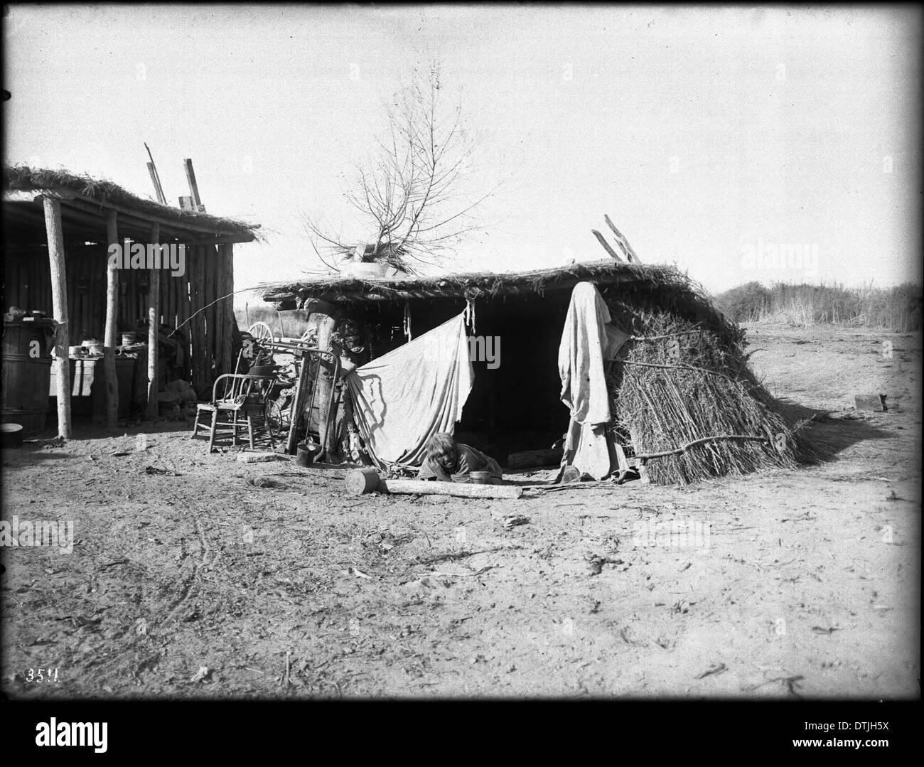 An elderly, blind Yuma Indian woman is shown laying in front of her ...