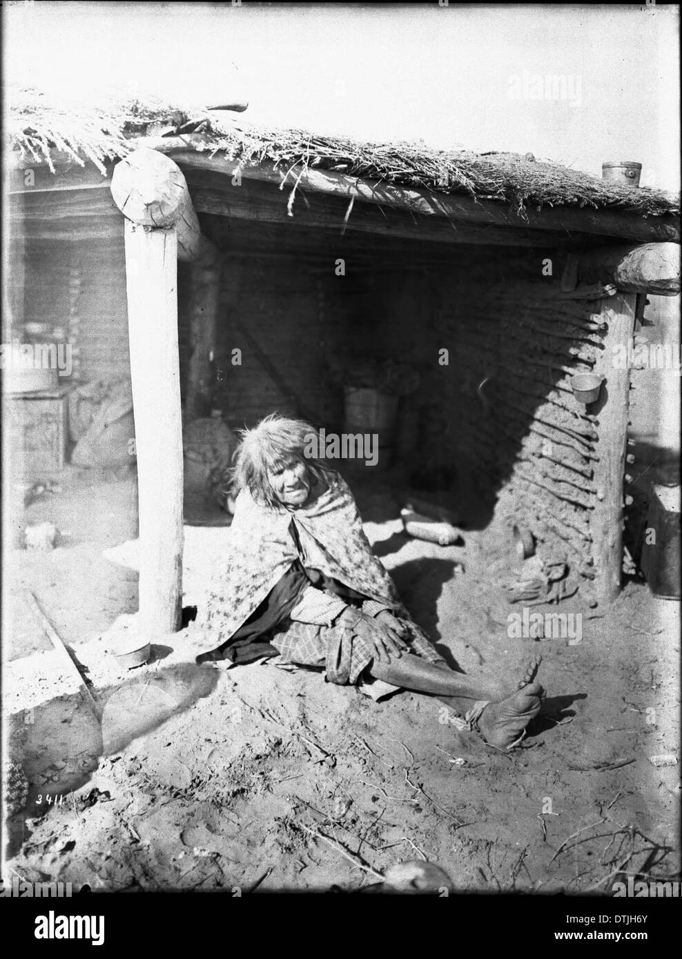A photograph of an elderly Mojave Indian woman sitting in a ramada ...