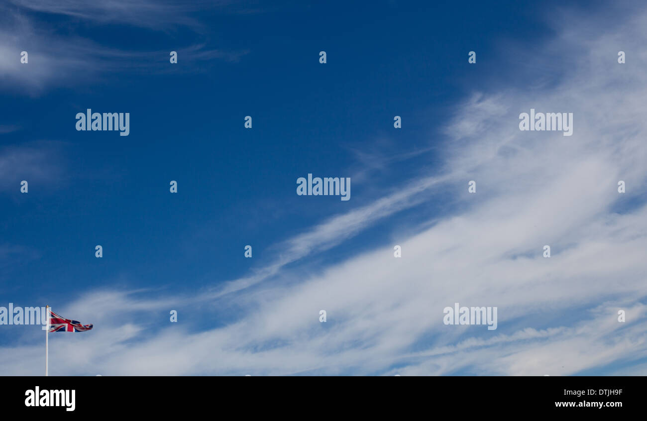 Union Jack flag on a blue sky background Stock Photo - Alamy