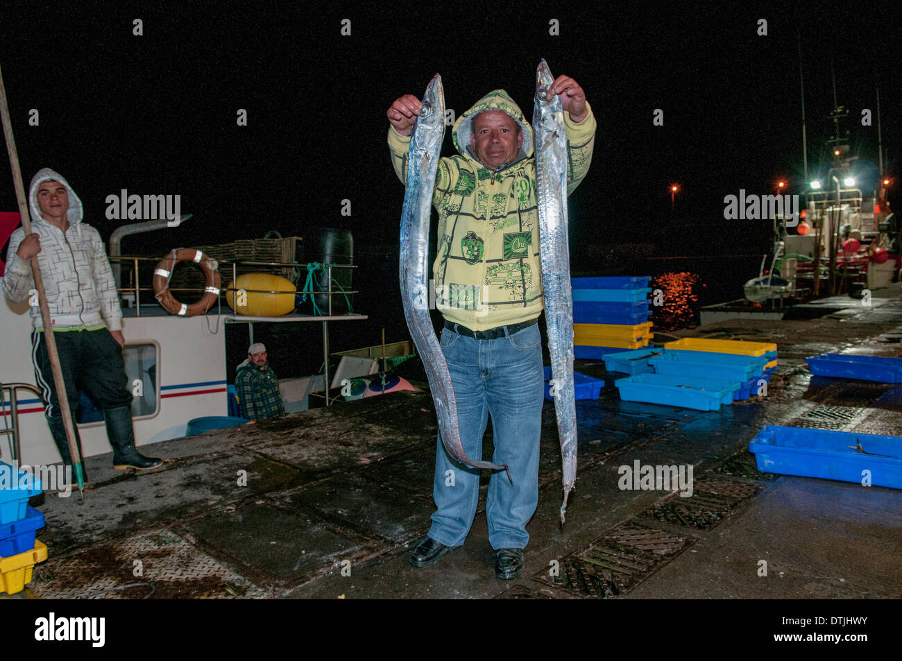 Fisherman holds Silver scabbardfish (Lepidopus caudatus). San Miguel ...