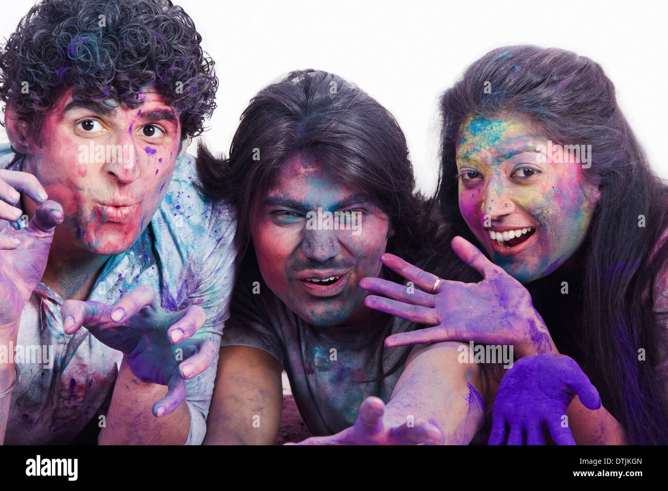 Portrait three friends playing holi hi-res stock photography and images ...