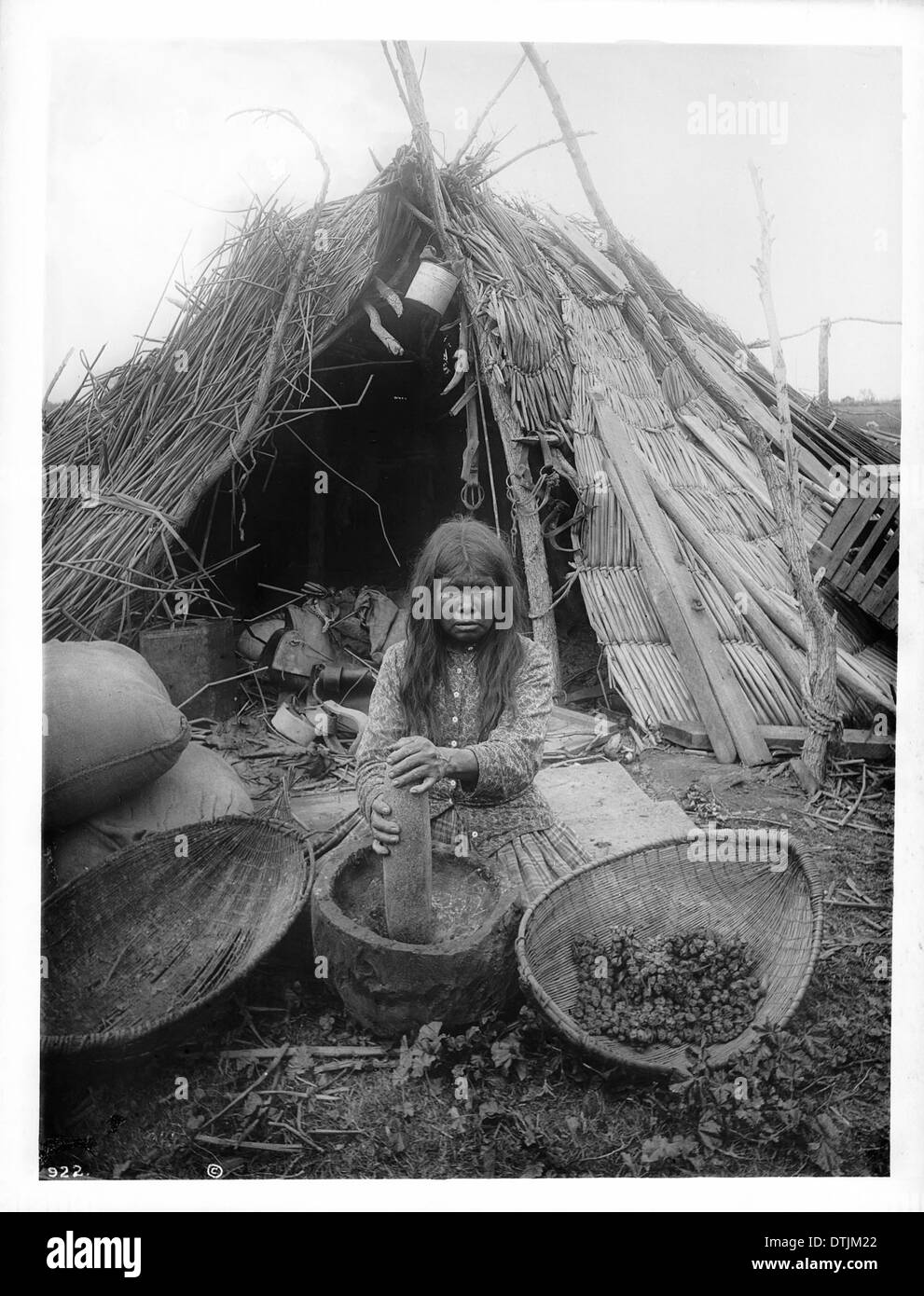 A Paiute Indian woman grinding acorns for flour in Lemoore, Kings ...