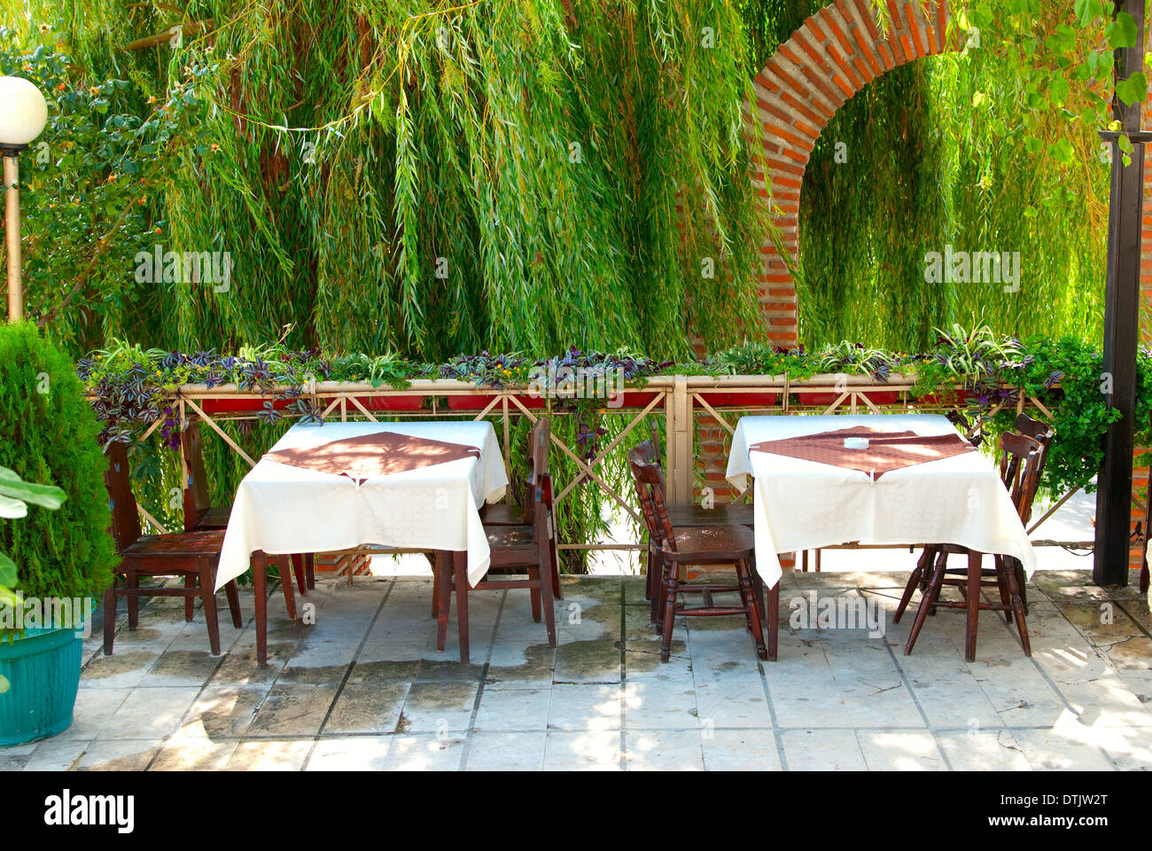 Tables in an outdoor restaurant Stock Photo - Alamy