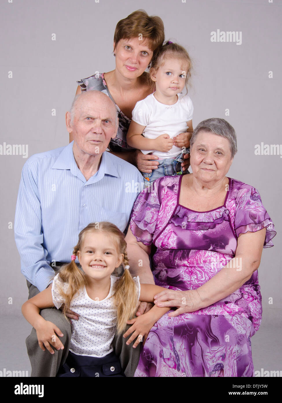 Group portrait of a family: two granddaughters grandmother, great ...