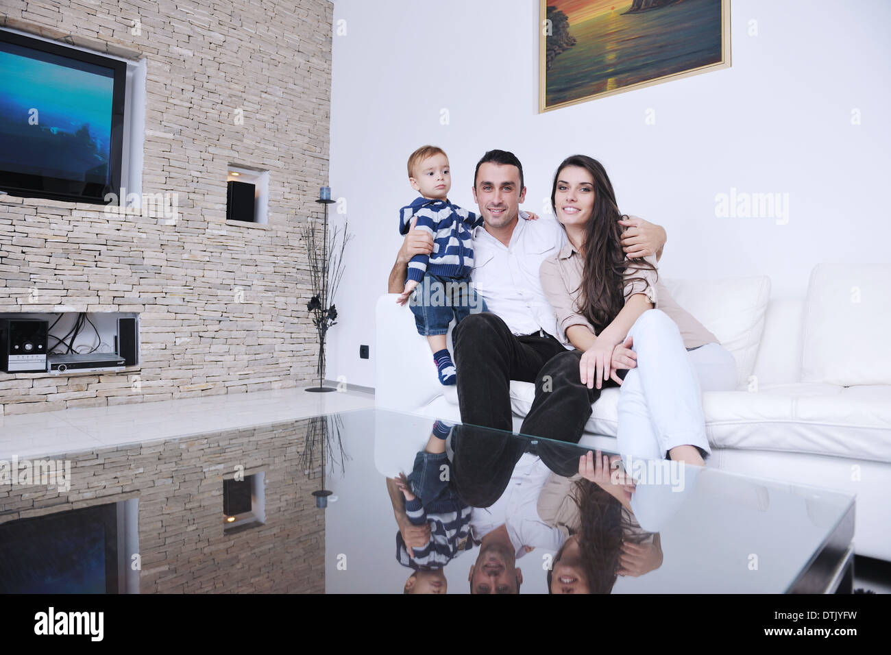 happy young family have fun with tv in backgrund Stock Photo - Alamy