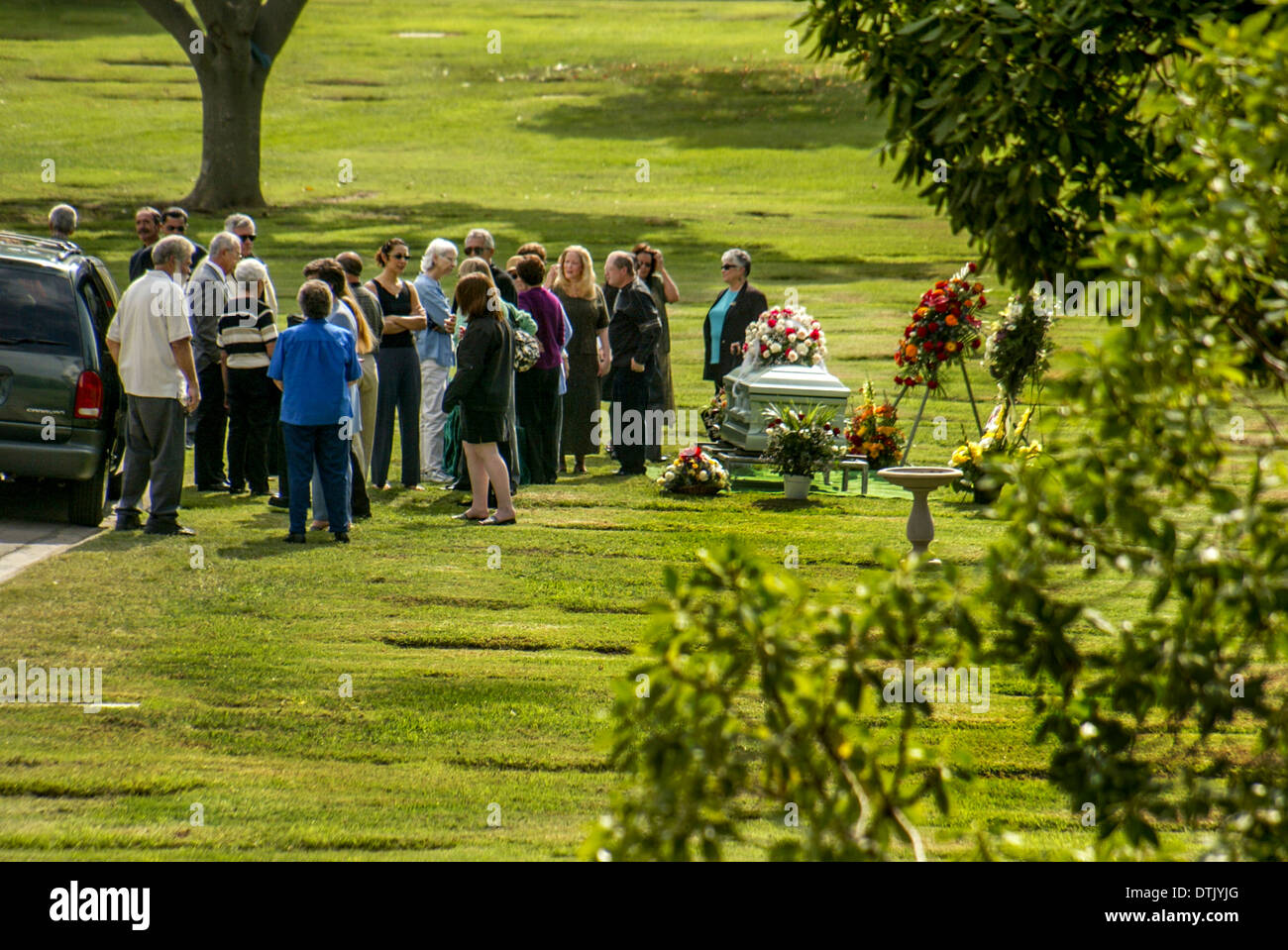 Family members gather after a burial ceremony at a Santa Barbara, CA ...