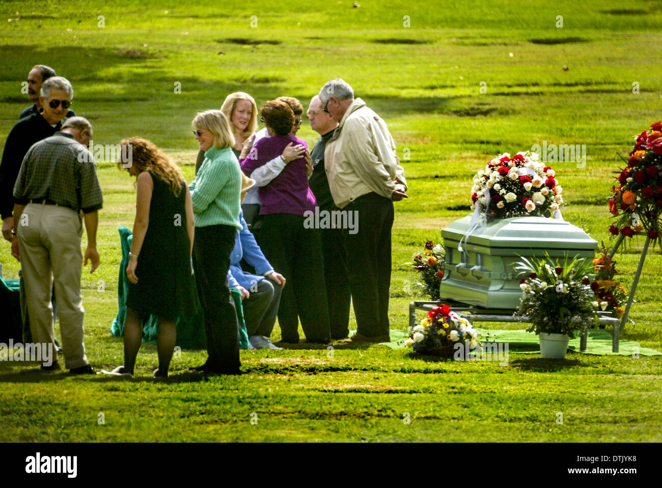 Family members gather after a burial ceremony at a Santa Barbara, CA ...