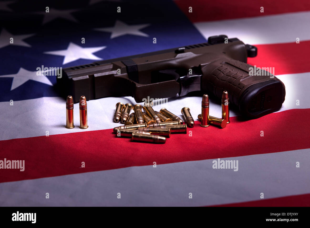Pistol on flag in the spotlight Stock Photo - Alamy