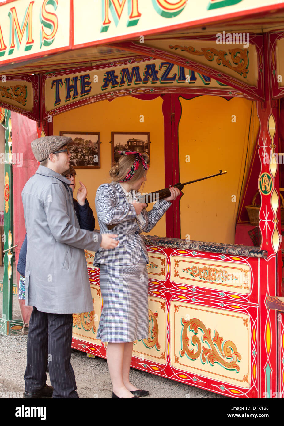 young teenage people girl girls boy friends at fairground shooting ...