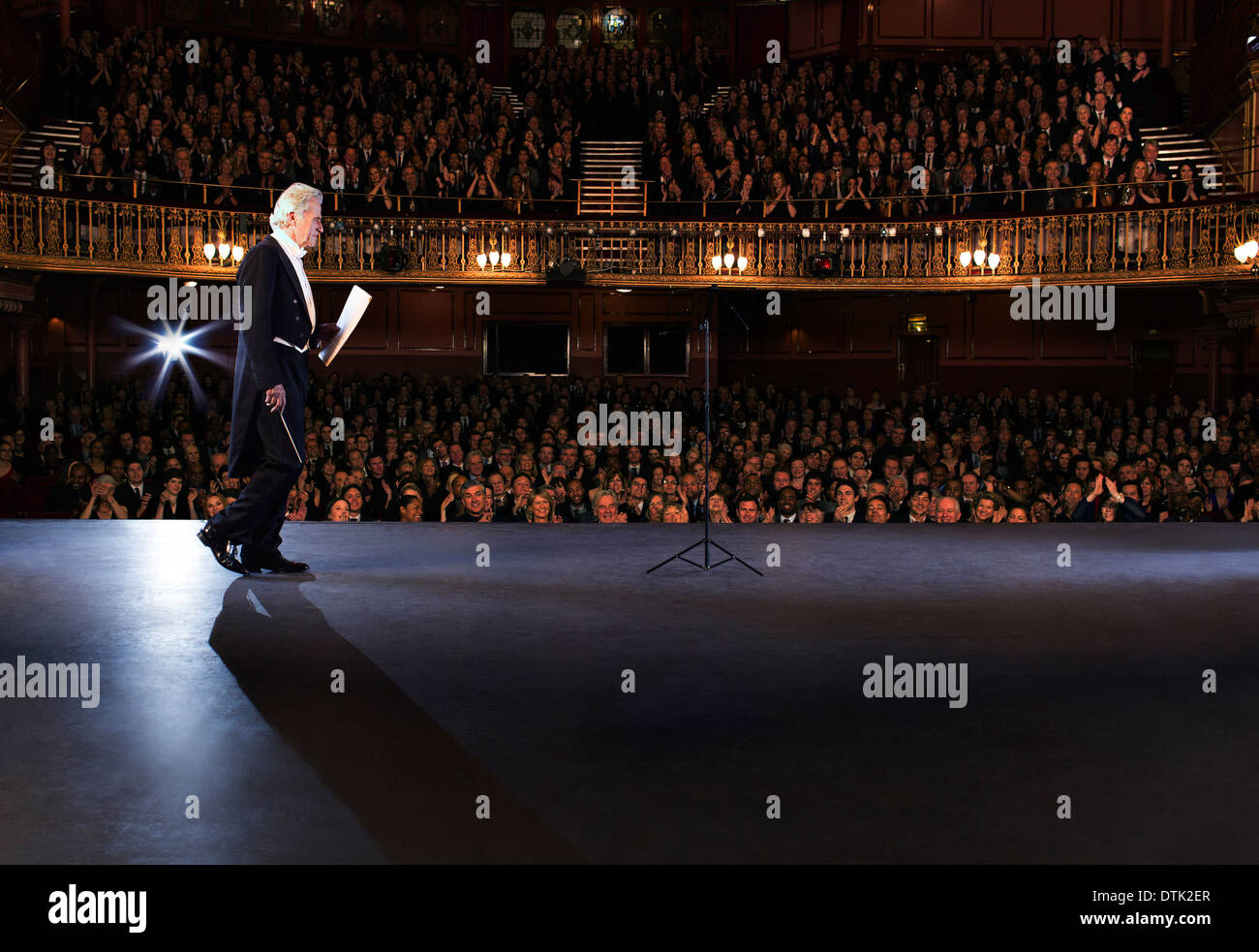 Conductor walking onto stage in theater Stock Photo - Alamy