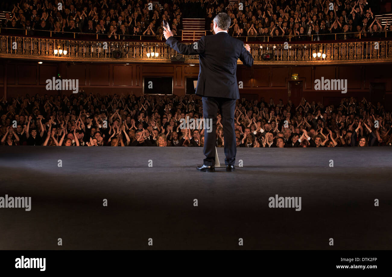 Audience clapping for conductor on stage in theater Stock Photo - Alamy