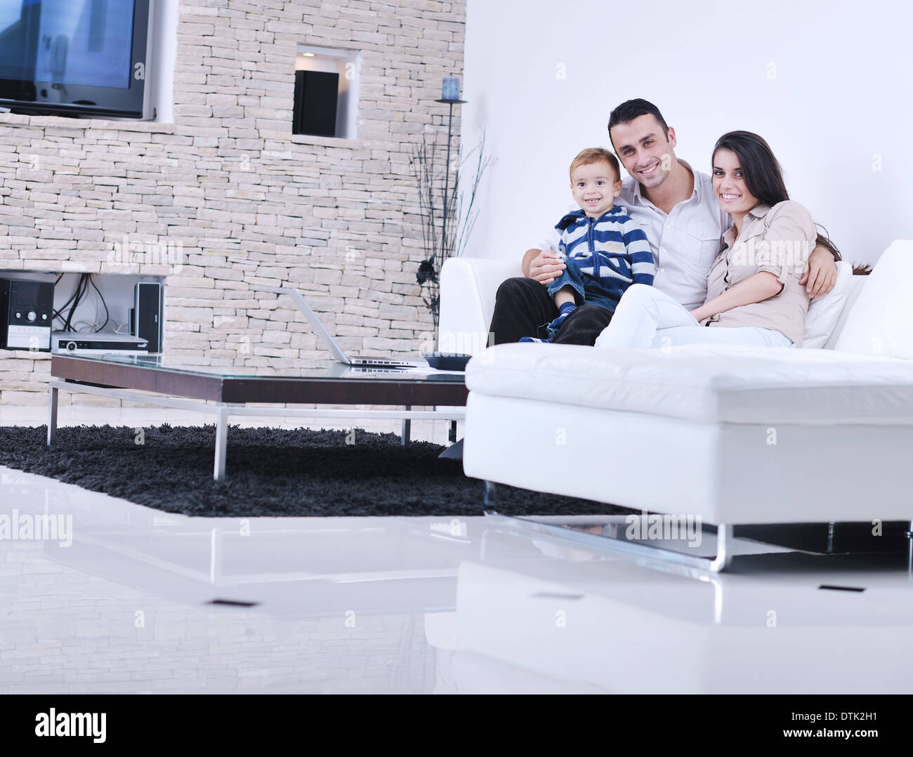 happy young family have fun with tv in backgrund Stock Photo - Alamy