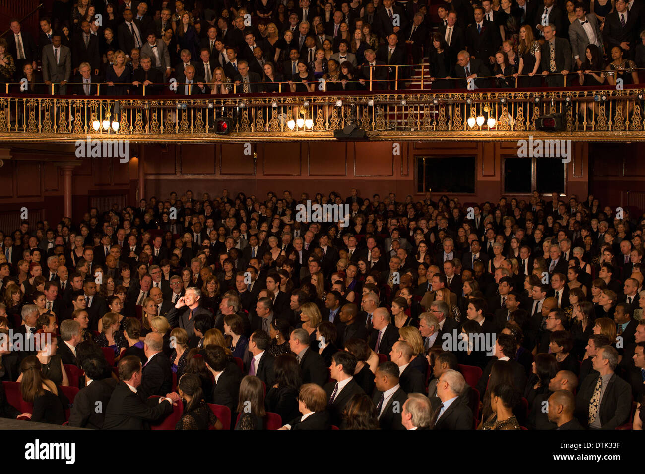 Spotlight on audience member using cell phone in theater Stock Photo ...