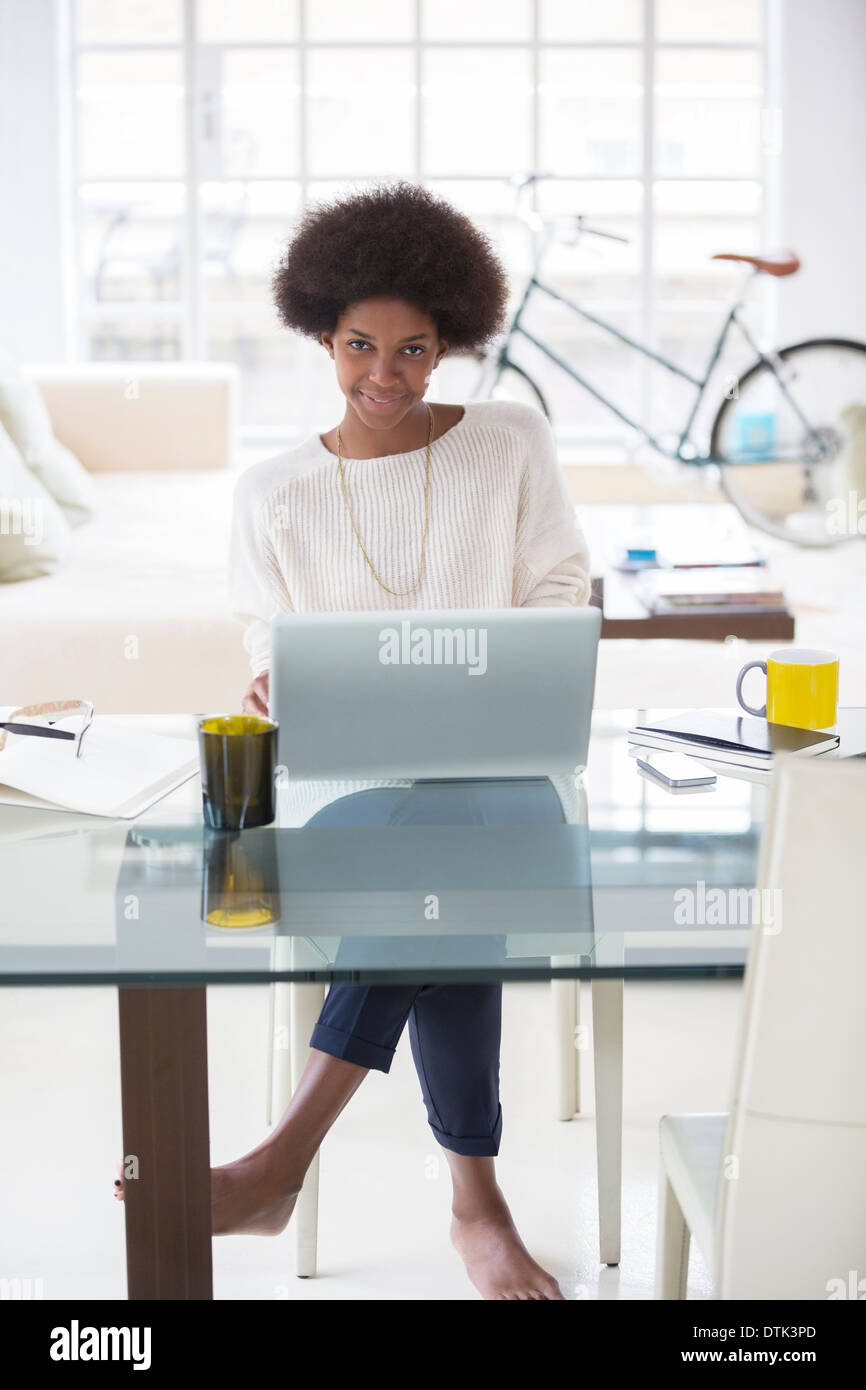 Woman using laptop at desk Stock Photo - Alamy