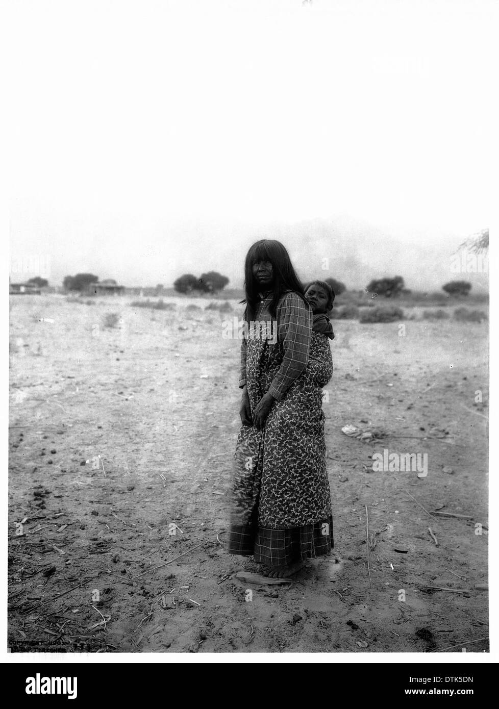 A photograph of a Pima Indian woman carrying her baby on her back ...