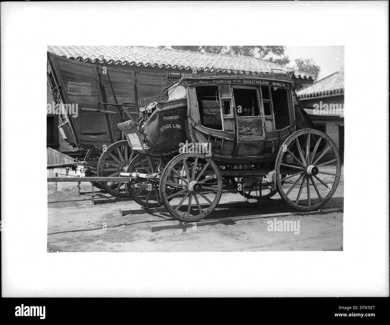 A Pioneer Stage Line coach displayed outside, captured around 1900 ...