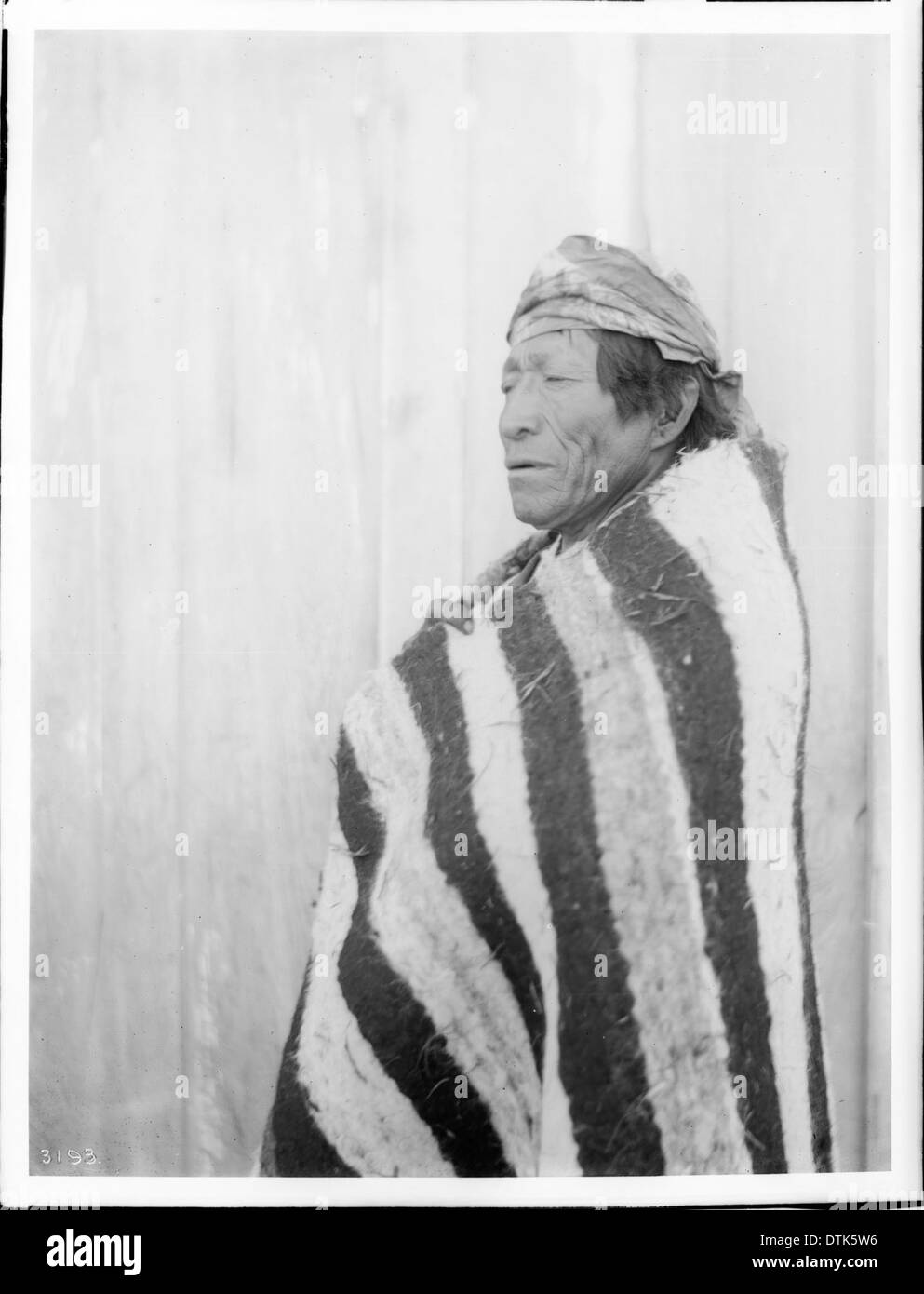 A portrait of Captain Big Water, a Walapai Indian, wrapped in a blanket ...