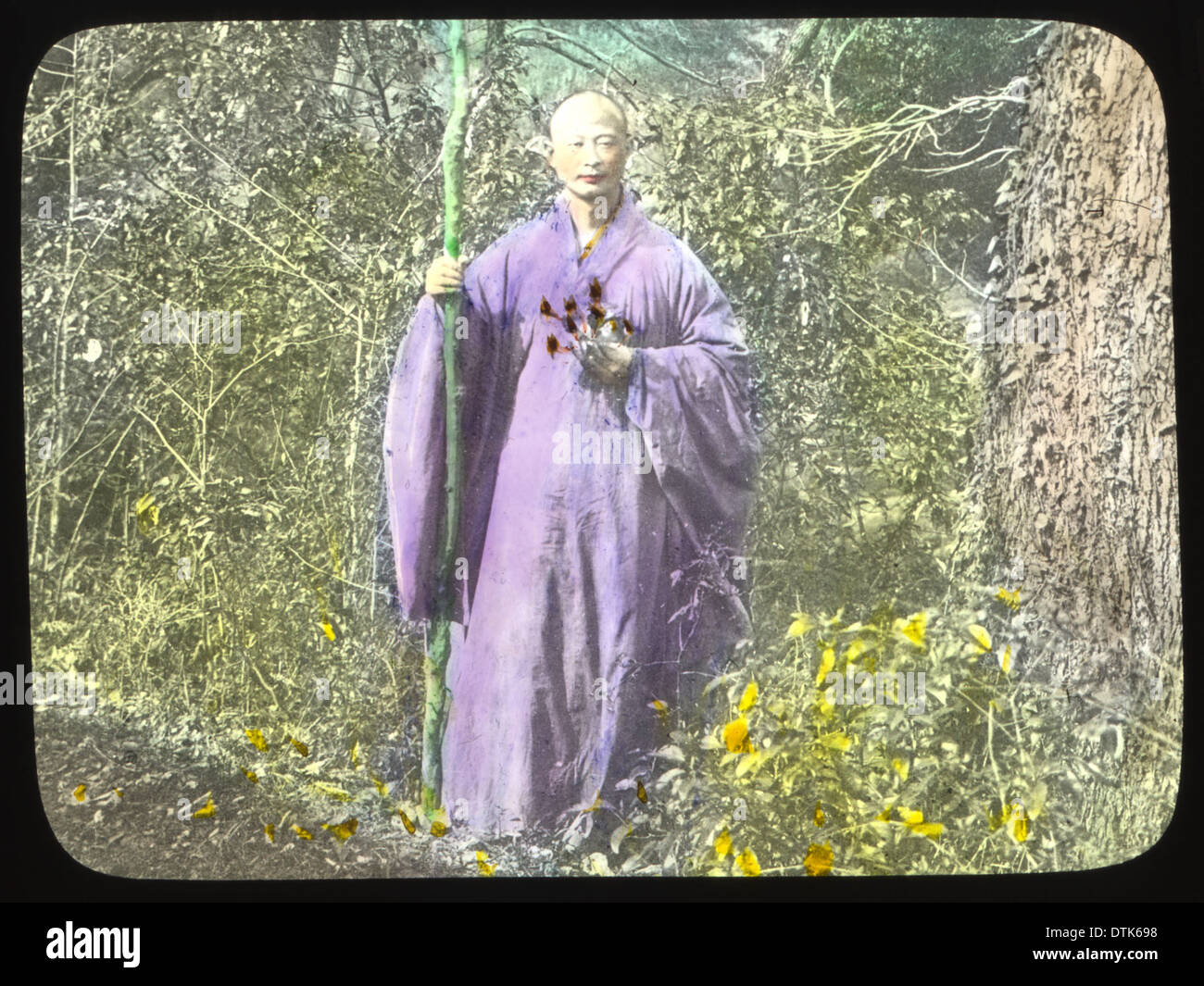 A photograph of a purple-robed priest standing outdoors in China, taken ...