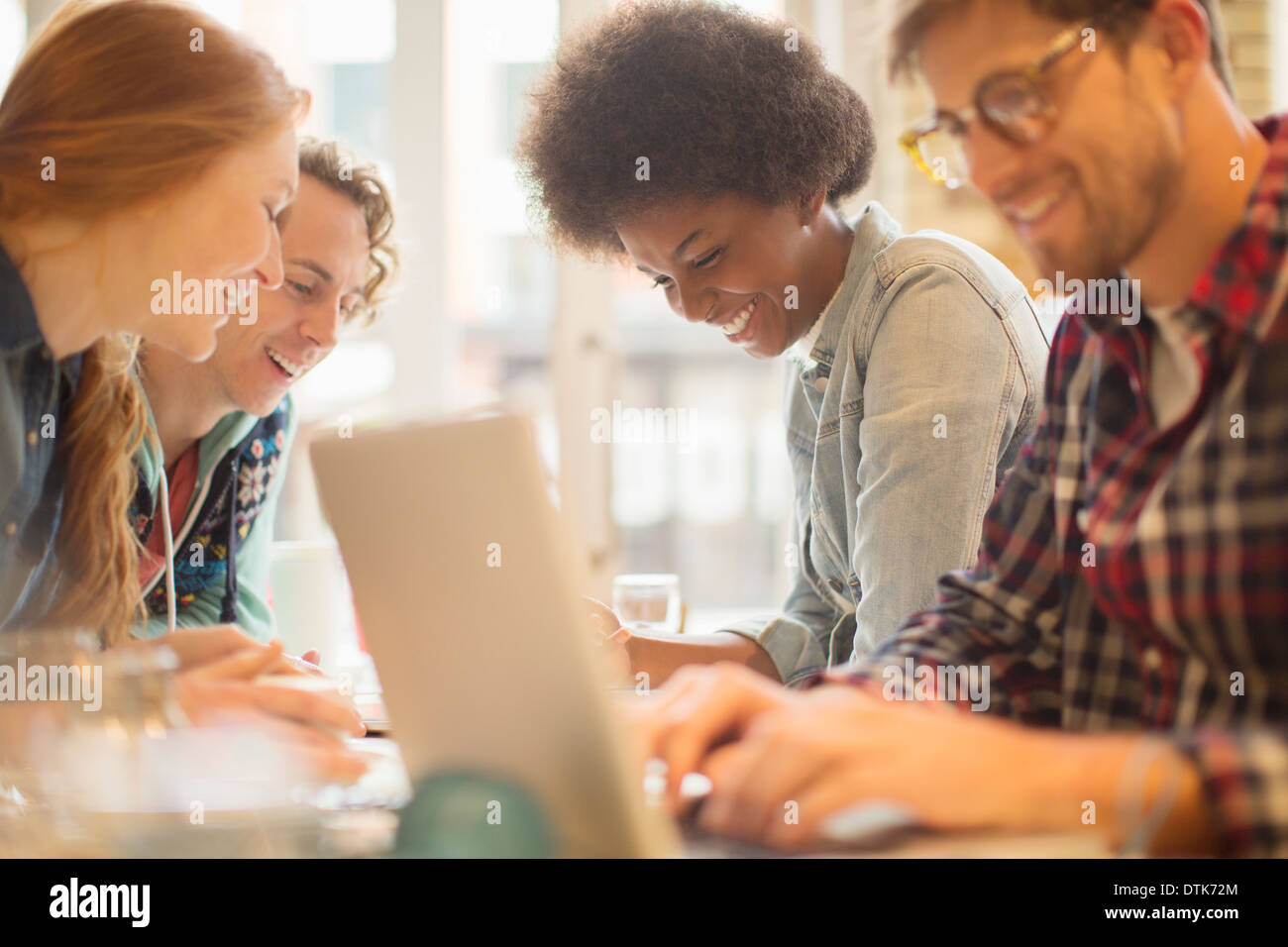 Friends working together at sidewalk cafe Stock Photo - Alamy