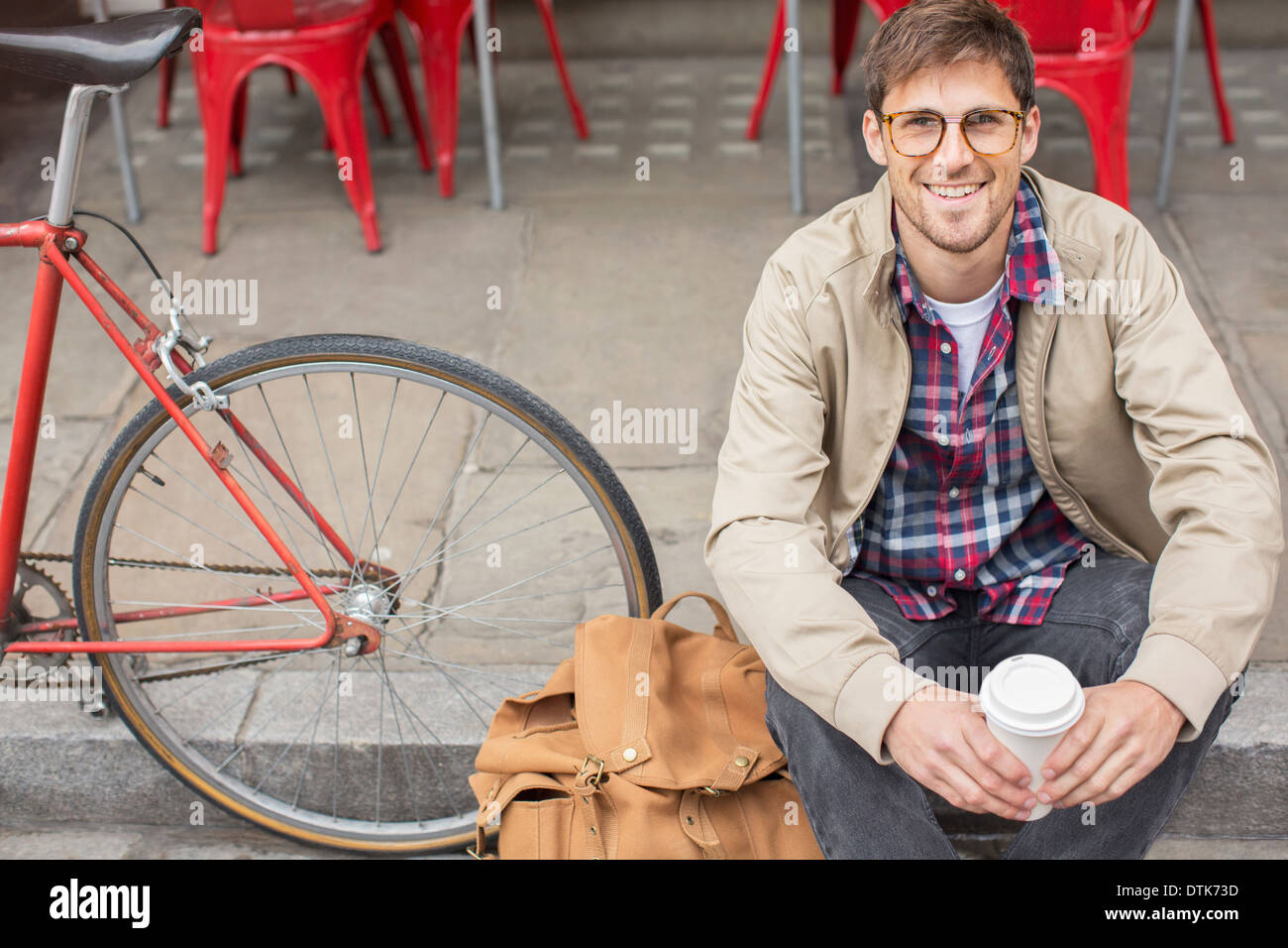 Man drinking coffee on city street Stock Photo - Alamy