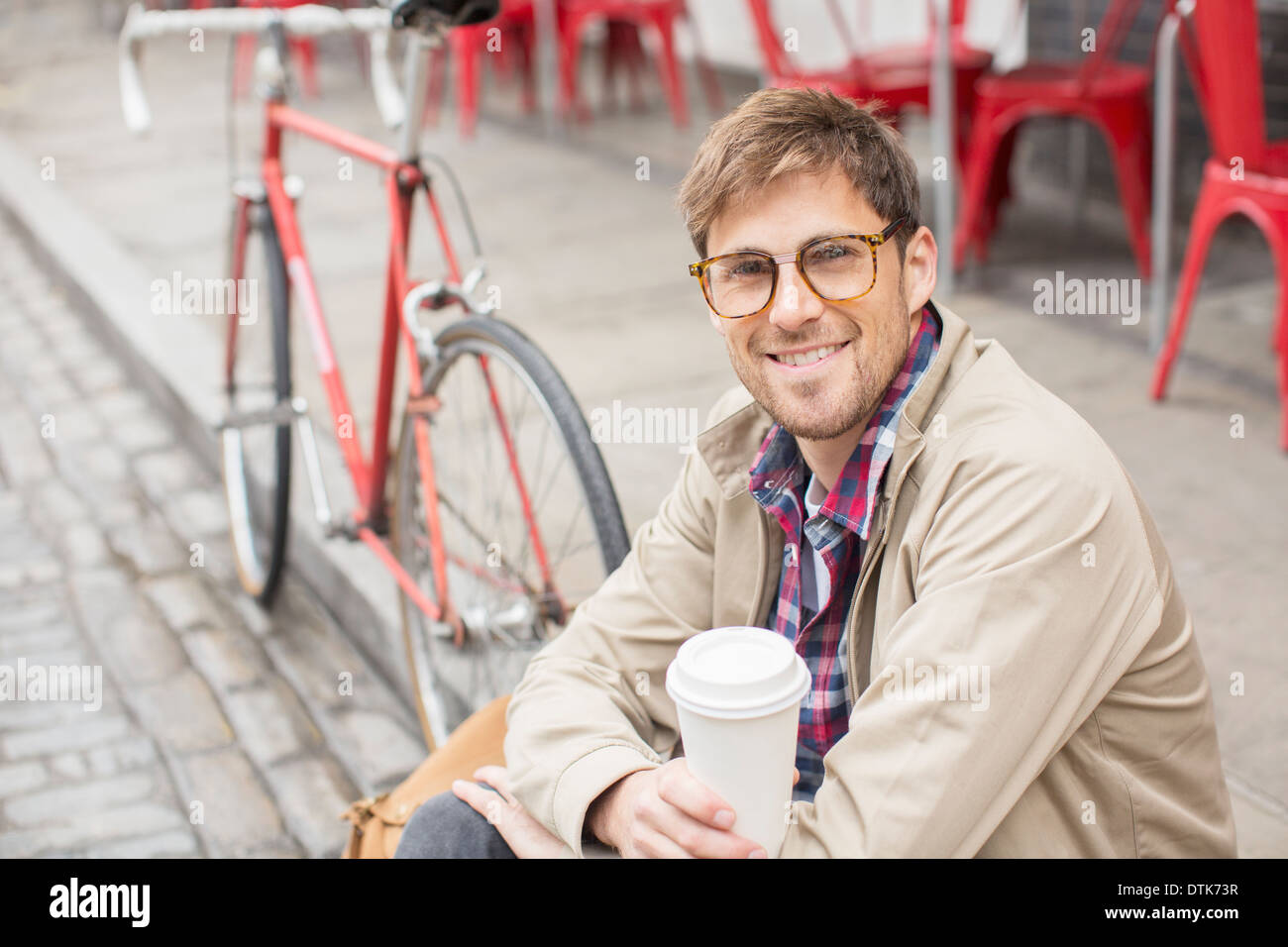 Man drinking coffee on city street Stock Photo - Alamy