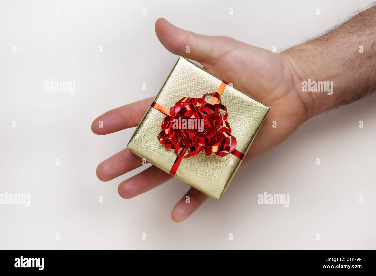 man's hand holding a small gift box with a ribbon around the box Stock ...