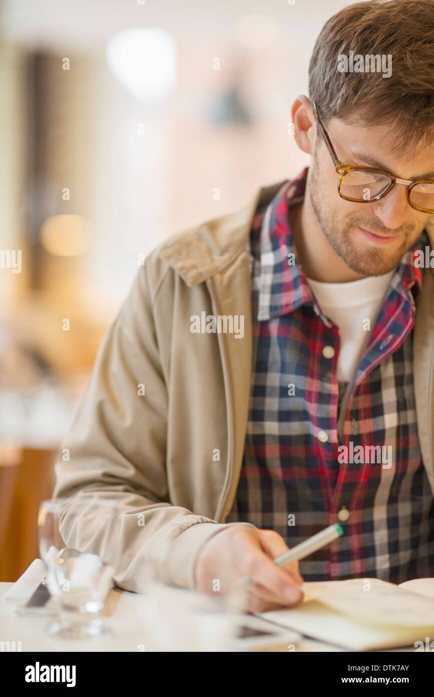 Coffee shop man writing on hi-res stock photography and images - Alamy