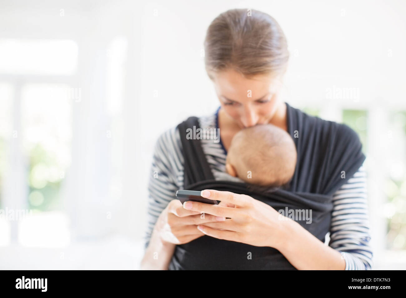 Mother with baby boy using cell phone Stock Photo - Alamy