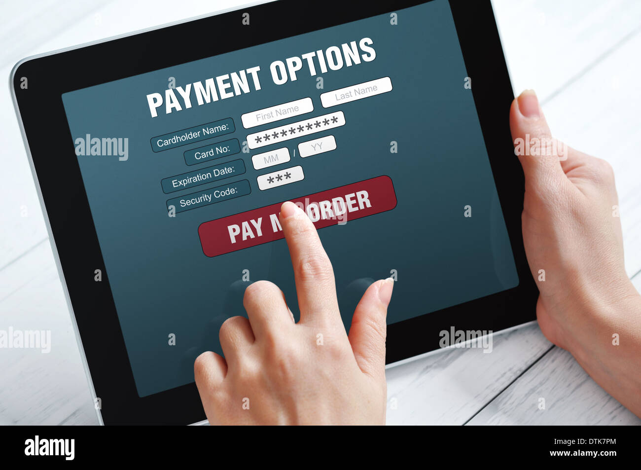 Female hands using touch screen device for online payment Stock Photo ...