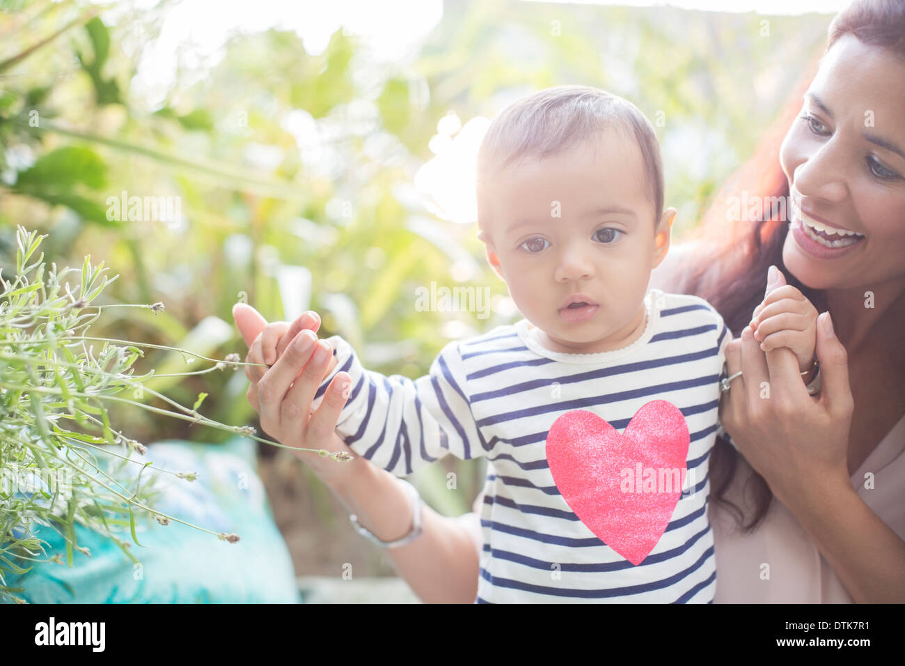 Mother helping baby boy walk outdoors Stock Photo - Alamy