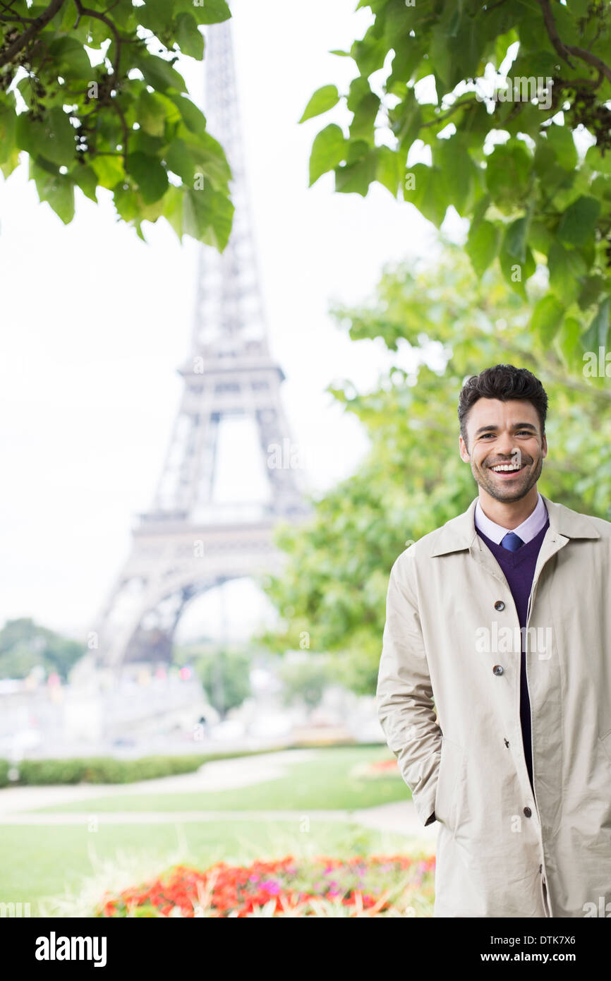 Businessman smiling near Eiffel Tower, Paris, France Stock Photo - Alamy