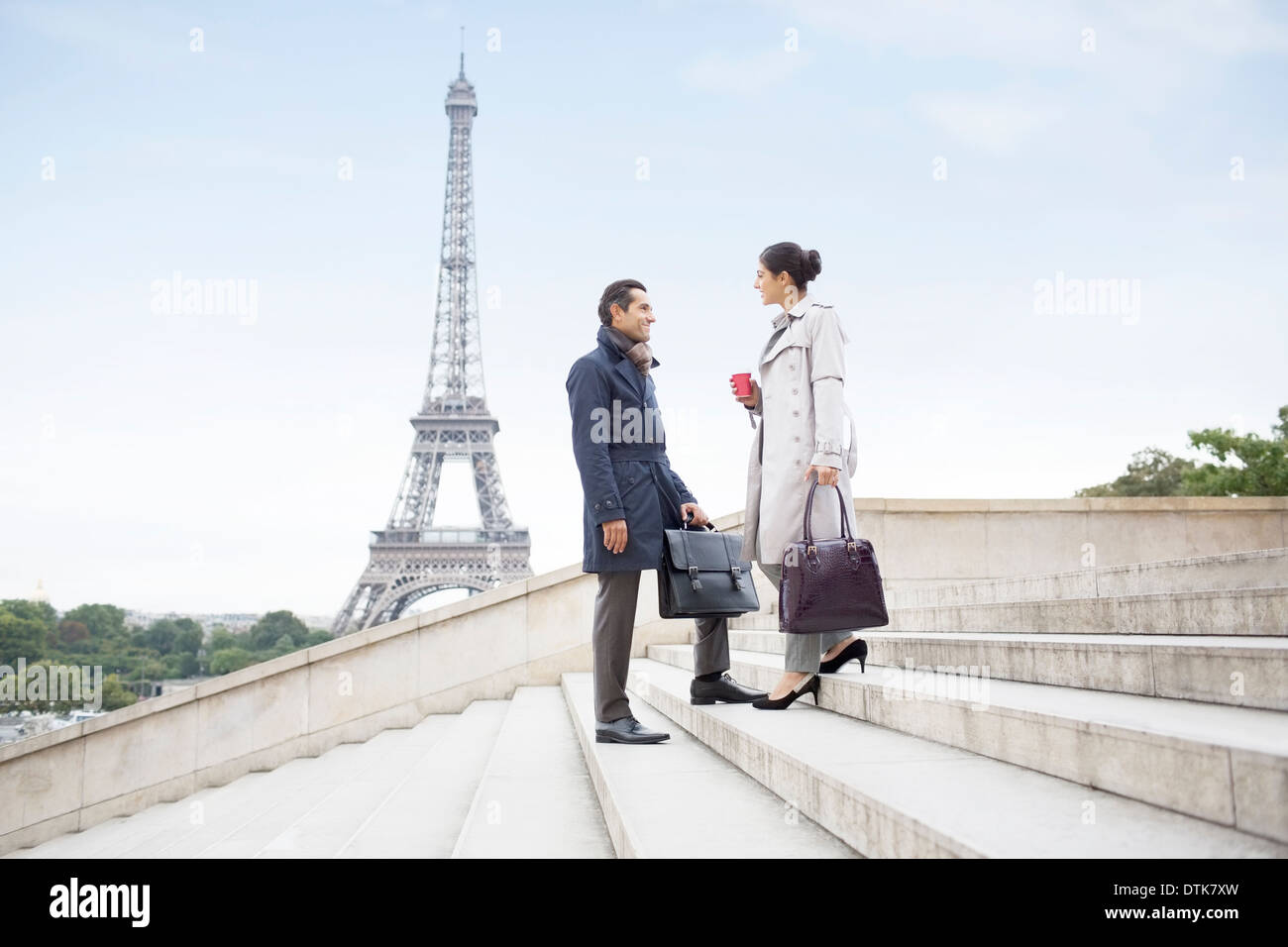 Business people talking on steps near Eiffel Tower, Paris, France Stock ...