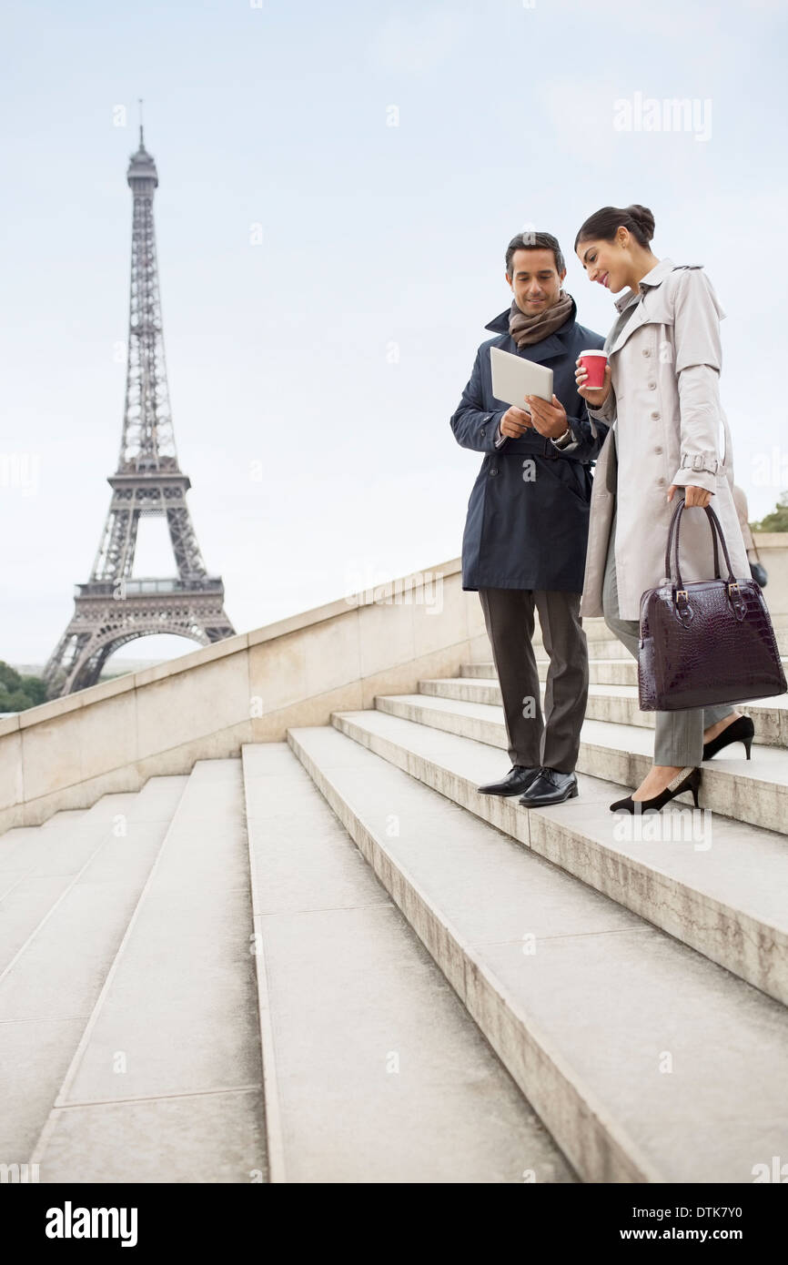 Business people talking on steps near Eiffel Tower, Paris, France Stock ...