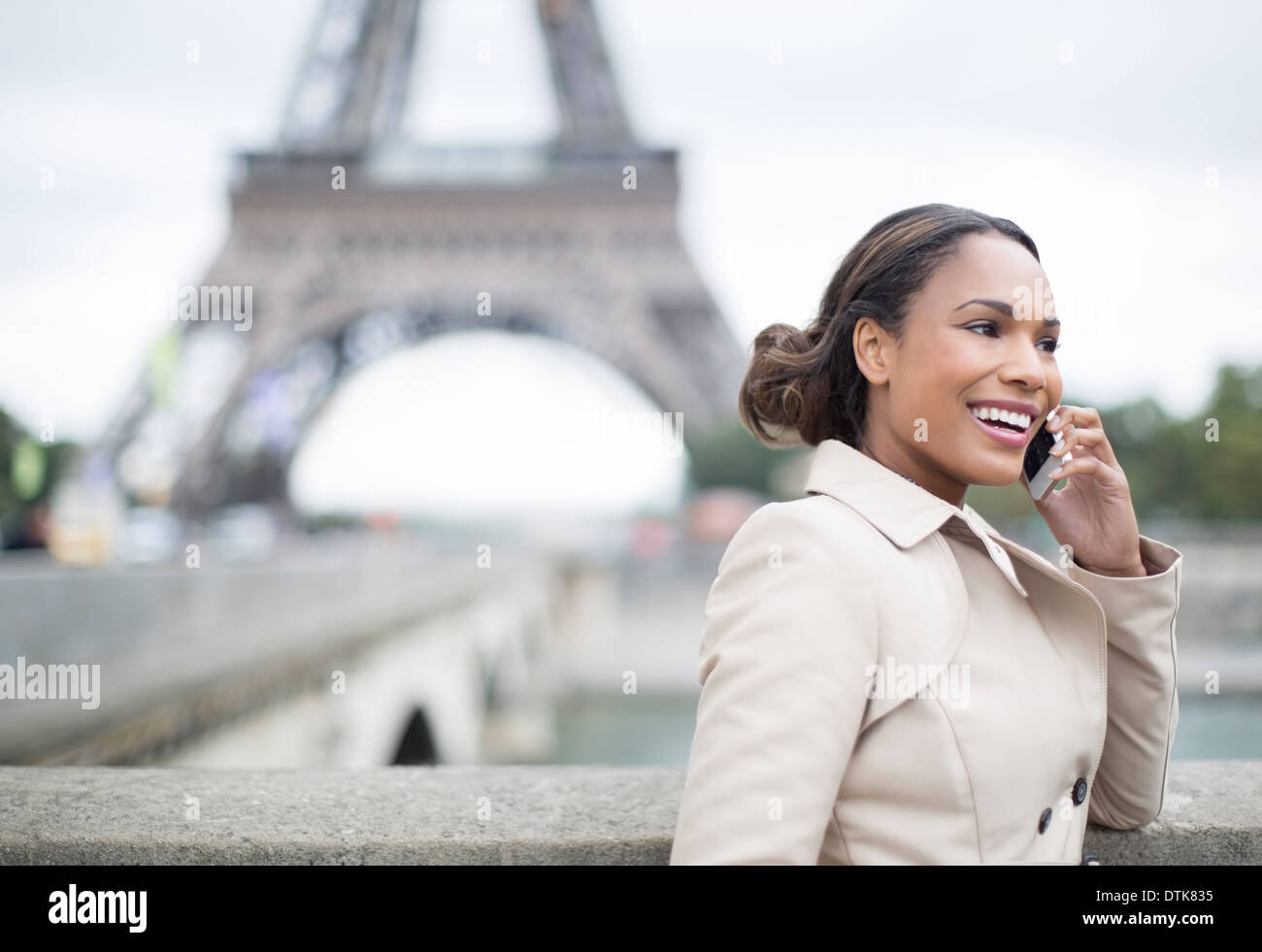 Businesswoman talking on cell phone near Eiffel Tower, Paris, France ...