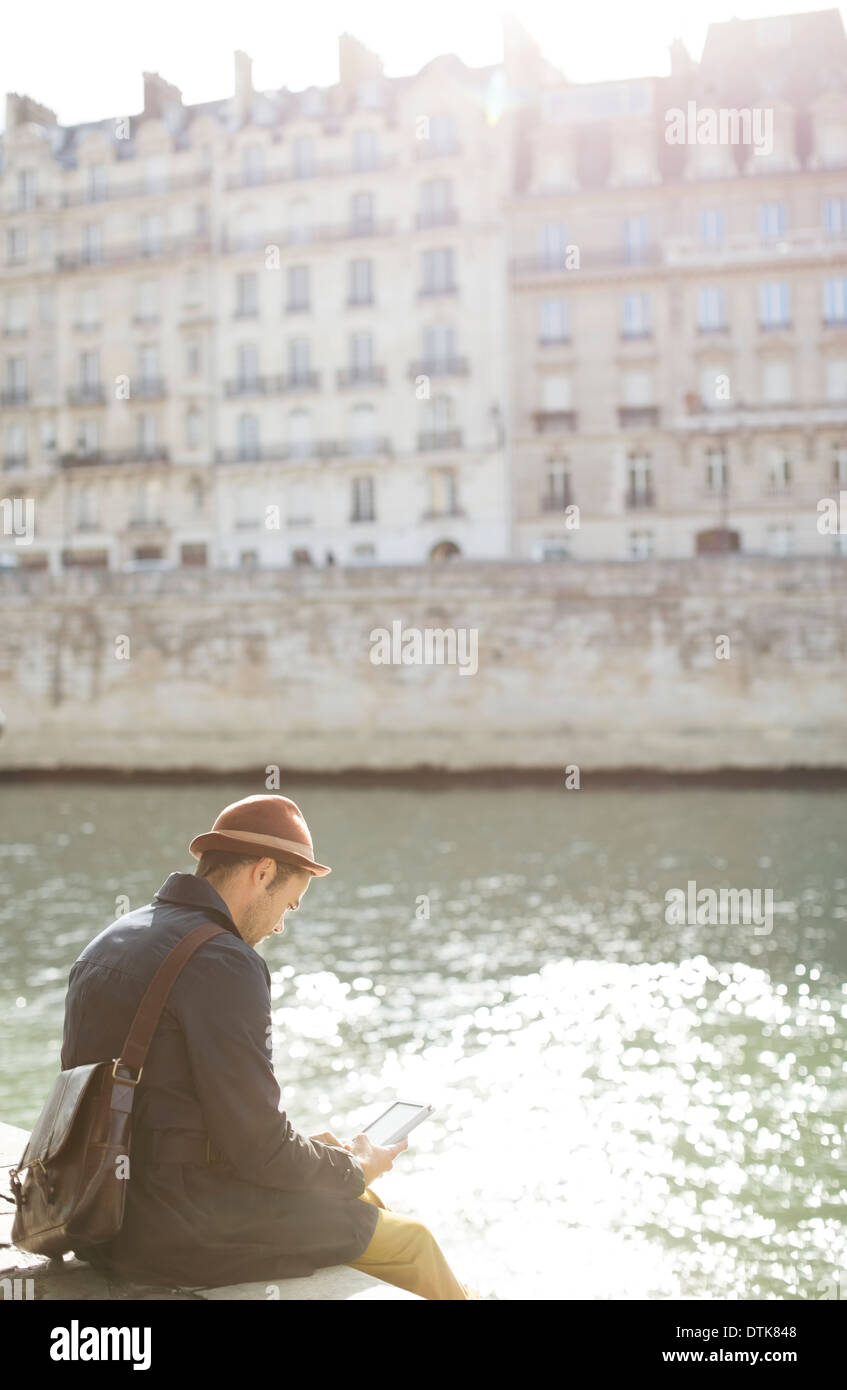Businessman using cell phone along Seine River, Paris, France Stock ...