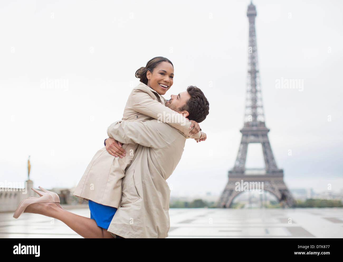 Couple hugging by Eiffel Tower, Paris, France Stock Photo - Alamy